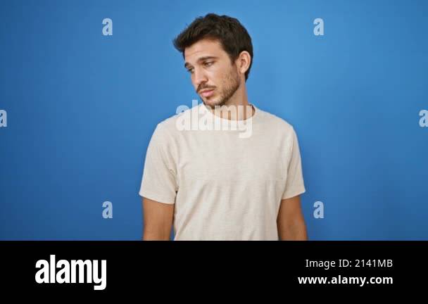 Handsome young hispanic man pointing to the side, standing isolated ...
