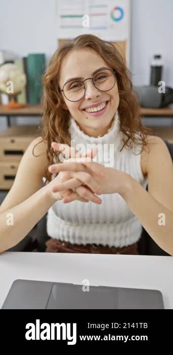 Happy young woman in office, confidently working and showing the number ...