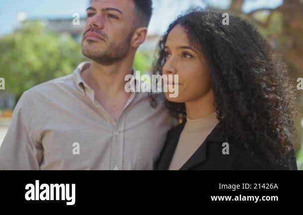 Intimate couple embracing outdoors, with affectionate woman and ...