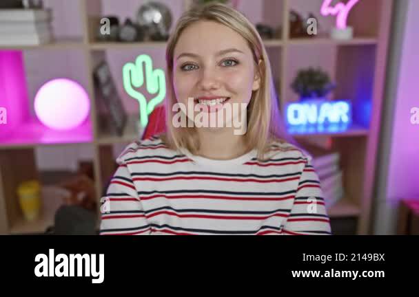 Victory! young blonde female streamer, flashing a cheerful v sign ...