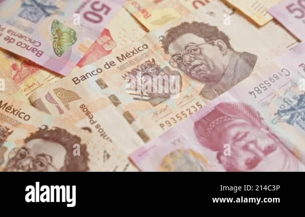 Mexican peso banknotes scattered detailing various denominations and ...