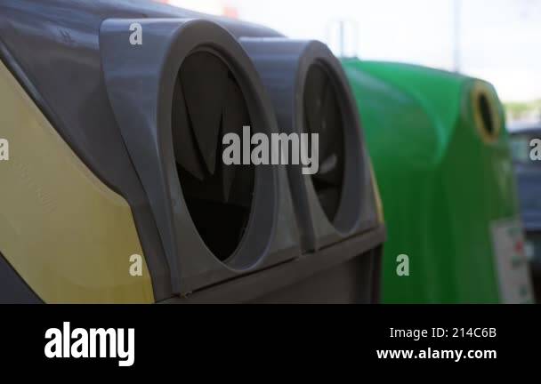 Closeup of urban recycling containers on a sunny day, featuring gray ...