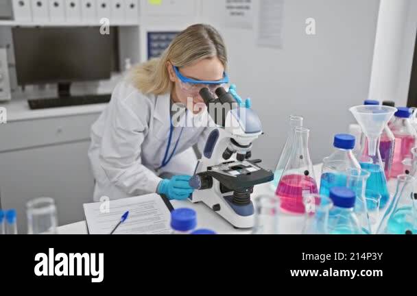 A joyful woman scientist celebrating a discovery in a laboratory filled ...