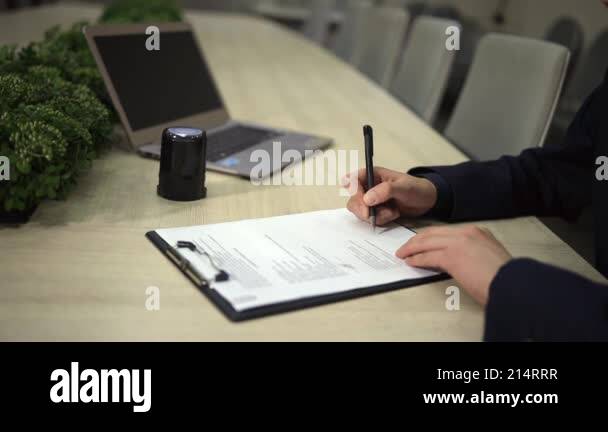 Official representative signing legal documents at contemporary ... Official representative signing legal documents at contemporary ...
