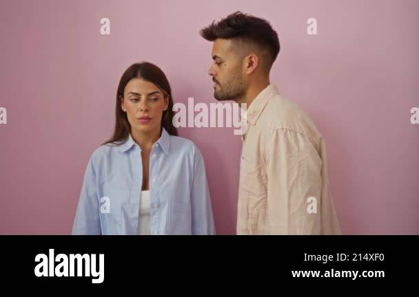 Woman rejecting advances from man against pink background showcasing ...