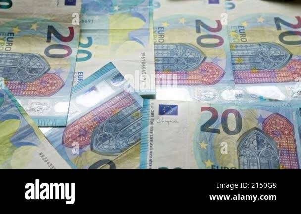 Twenty-euro banknotes from the european union are scattered, showcasing ...