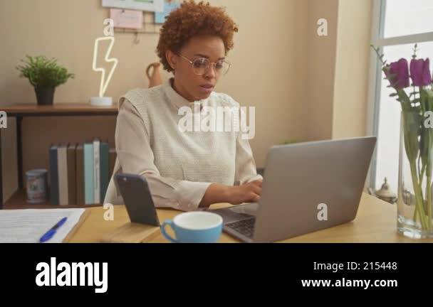 Confident and punctual, stunning african american woman sits at home ...