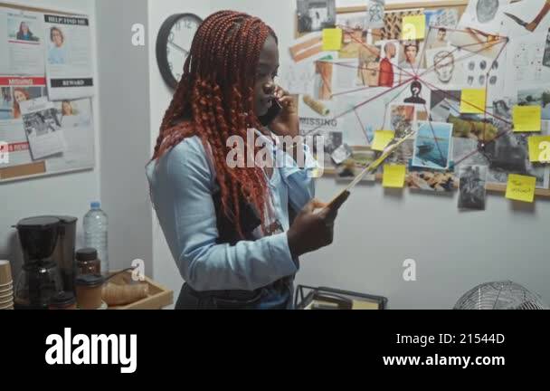 African american detective woman investigates in office, analyzing ...