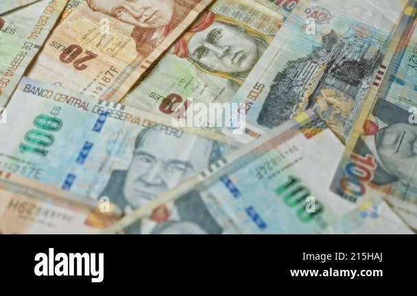 Peruvian banknotes arranged in a scattered manner showcase various ...