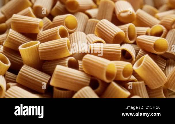 Closeup detailed shot of uncooked short pasta tubes, showcasing texture ...
