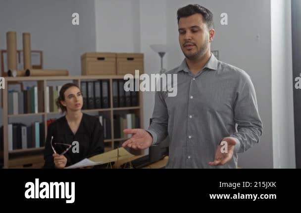 Lawyer talking while judge listens to him attentively in a courtroom ...