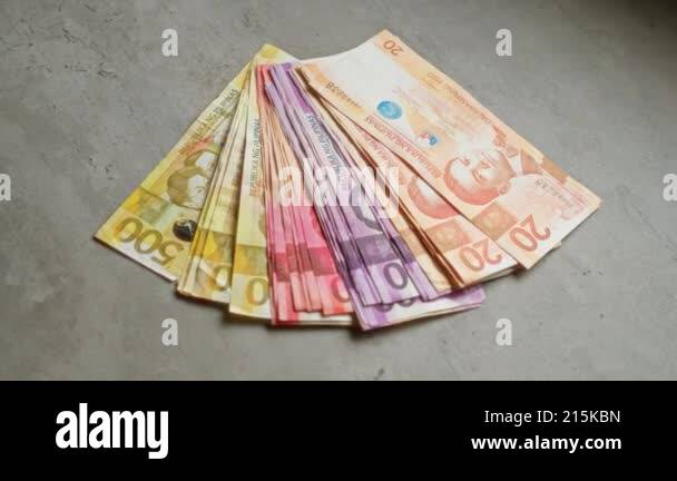 Philippine banknotes neatly arranged on a concrete surface showcasing ...