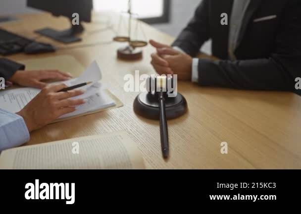 Man putting hands on face worried discussing with lawyer in office with ...