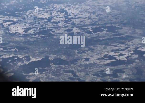 Top bird eye View from passenger porthole of beautiful landscape Flying airplane engine wing of ...
