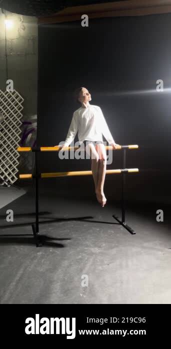 A young dancer engages in ballet practice on a barre in a chic studio ...