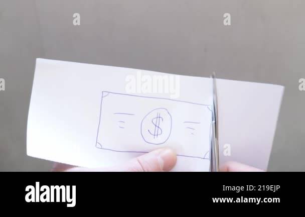 Man cuts out drawn dollar with scissors. Concept of money depreciation ...