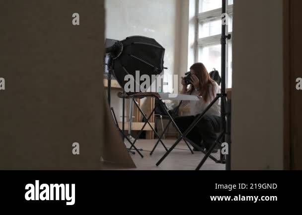 Female photographer taking photo of objects on background in photo ...
