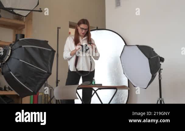 Female photographer taking photo of objects on background in photo ...