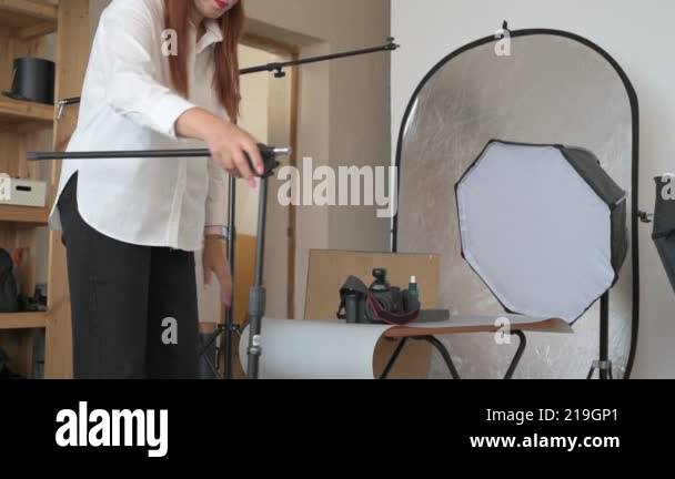 Female photographer taking photo of objects on background in photo ...