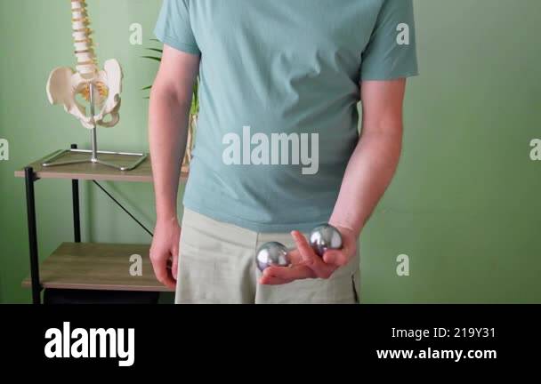 A man rolling Chinese Baoding balls in his palm for stress relief ...