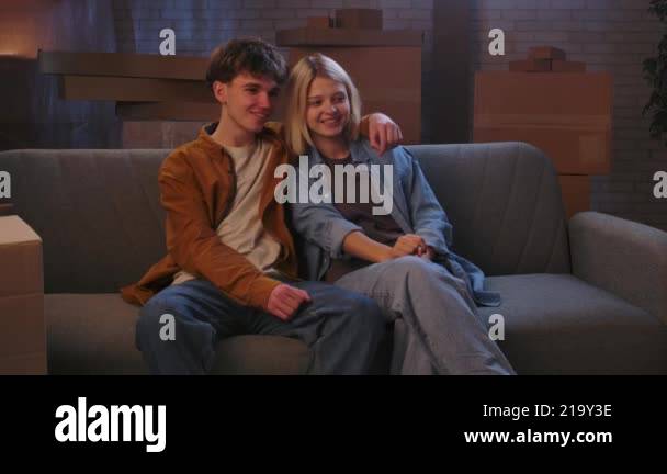 A young man and woman are in the living room discussing a housewarming ...