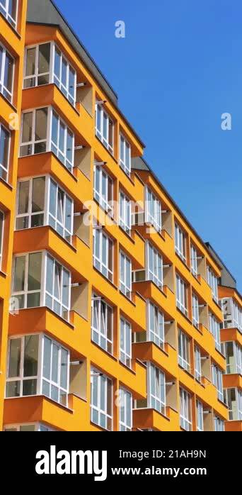 Bright city architecture against blue sky. New apartment building in ...