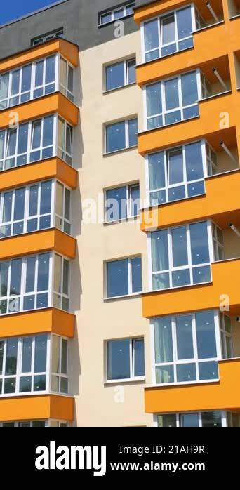 Modern high rise building with glazed balconies. Front view of newly ...