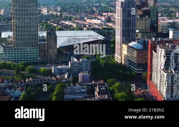 Aerial view of Rotterdams modern cityscape and train station, lush ...