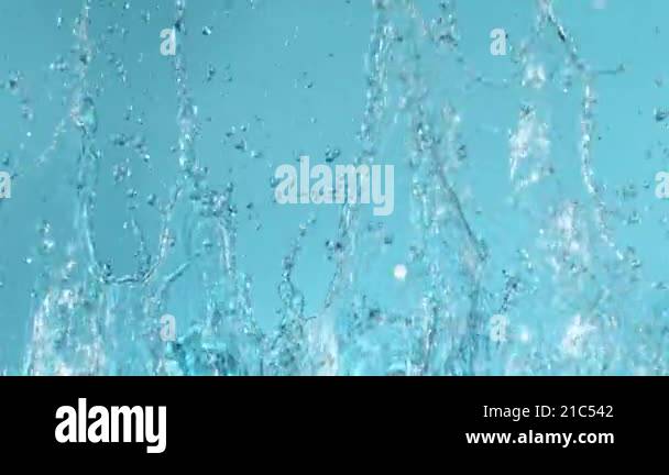 Slow motion of splashing water on light blue background , filmed on ...