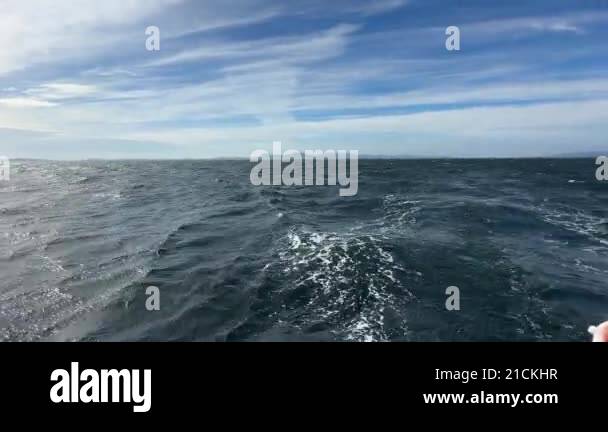 Video footage of a boat travelling along on the ocean making waves ...