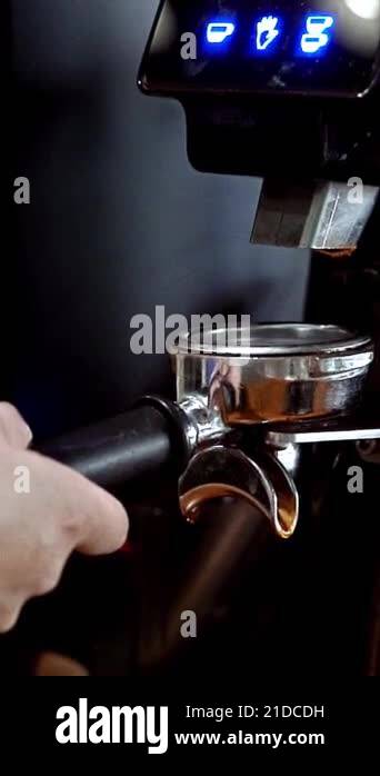 Barista activating espresso machine, close-up of finger pressing ...