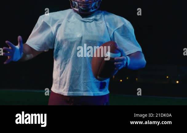 Portrait of determined professional American football player in helmet ...