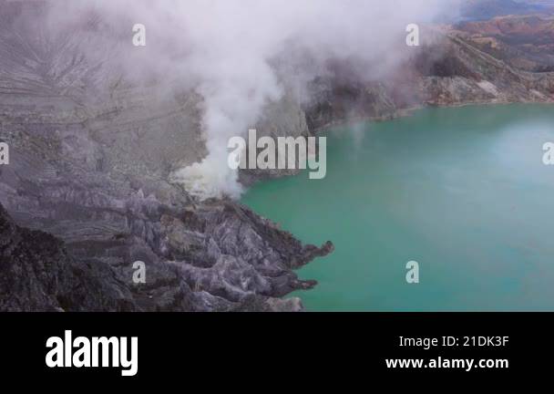 Sulfur smoke rising from Ijen crater over acid lake in Java island ...