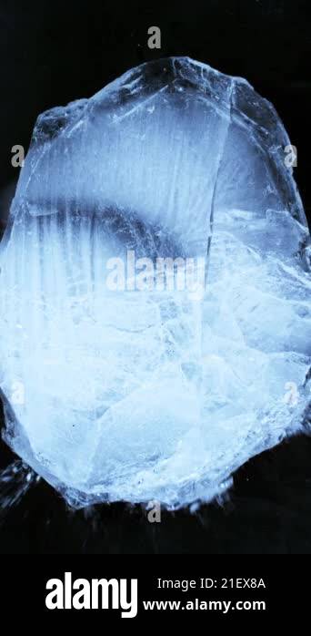 Super Slow Motion Of Falling Piece Of Ice On Black Background Filmed On High Speed Cinema