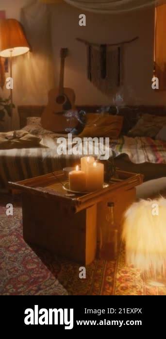 Full vertical no people shot of smoking incense and candles burning on ...