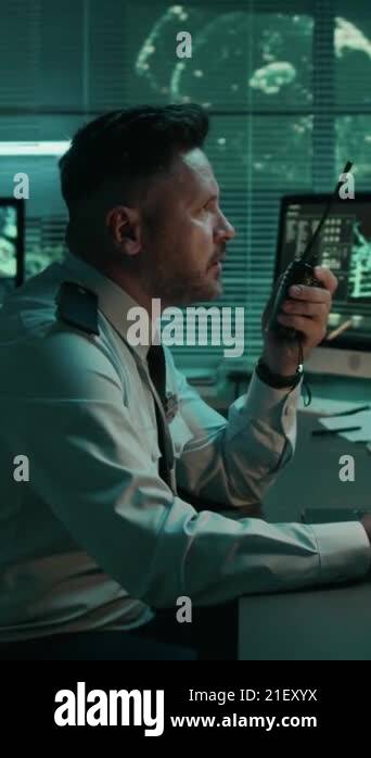 Medium vertical shot of Caucasian male military analyst working on ...