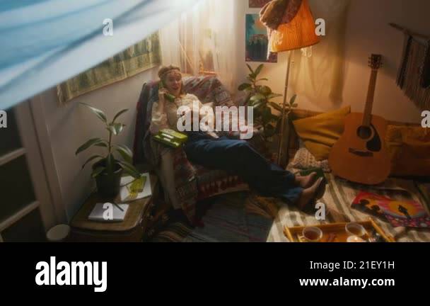 Full shot with lens flare of cheerful young Caucasian hippie girl ...