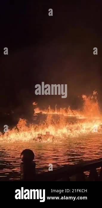 Fire Line Isolated on Black Background. Flames are Reflected in Water ...