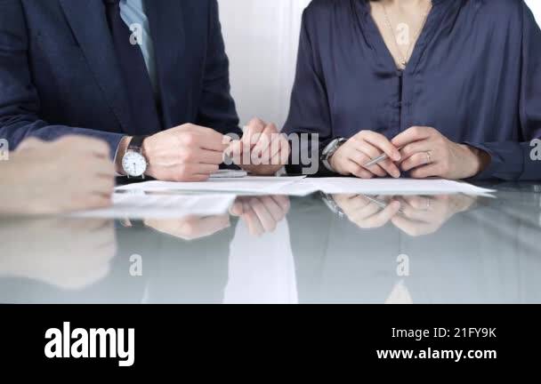 Business partners or lawyers are reviewing contract terms during a ...