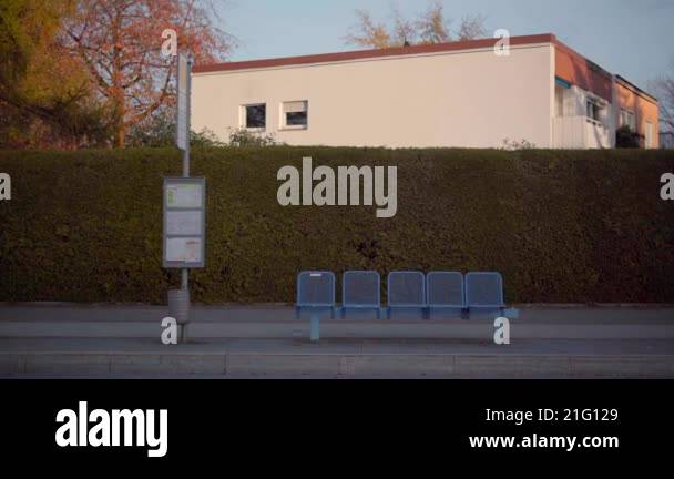 This bus stop in Bavaria, Germany, is set in autumn. It has blue ...