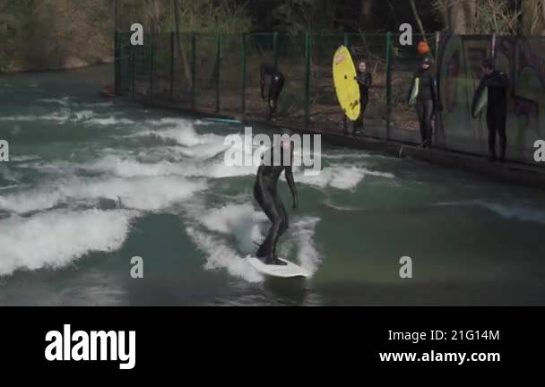 March 25, 2022. Munich, Germany. Surfers surfing an River Isar in ...