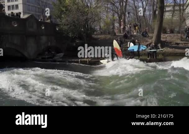 March 28, 2022. Munich, Germany. Eisbachwelle am Englischen Garten ...