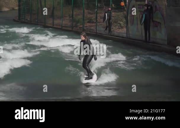 March 25, 2022. Munich, Germany. Surfers surfing an River Isar in ...