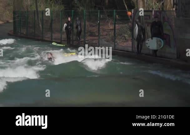 March 25, 2022. Munich, Germany. Surfers surfing an River Isar in ...