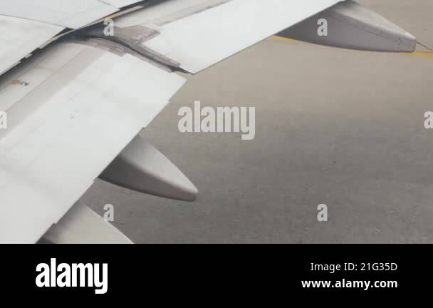 view to rear wing of a airplane with flaps deploy position ready to ...