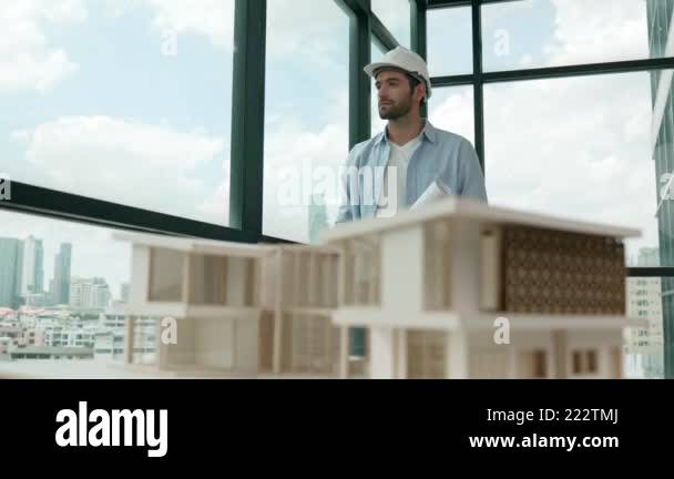 Professional architect engineer walking while looking at skyscraper ...
