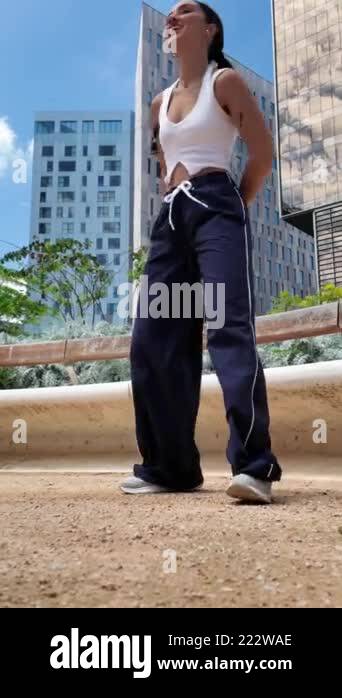 Dynamic dancer performing fluid, expressive movements against urban ...