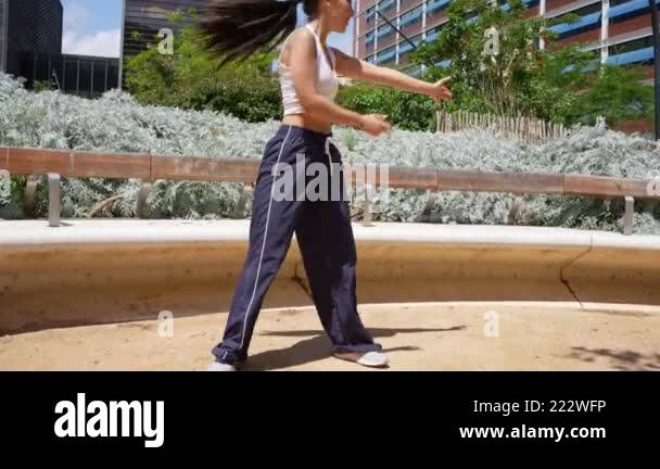 Female dancer grooving with passion through urban park, expressing ...