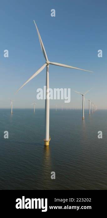 Explore the stunning landscape of the Netherlands as towering wind ...