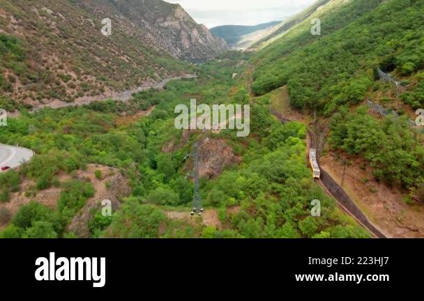 Aerial view of the little yellow train in picturesque Pyrenees ...